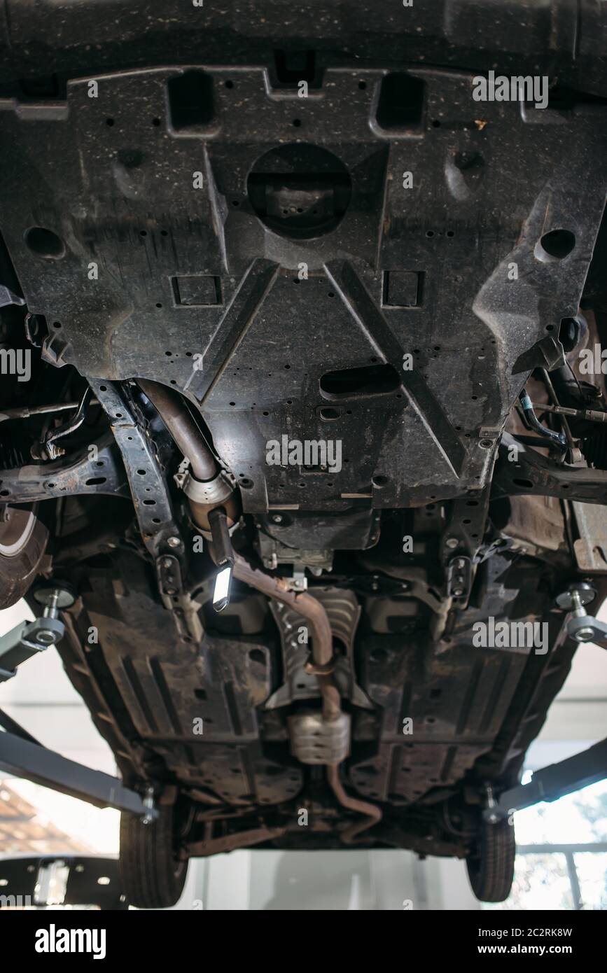 Car on the lift, bottom view, nobody. Automobile repair, vehicle ...