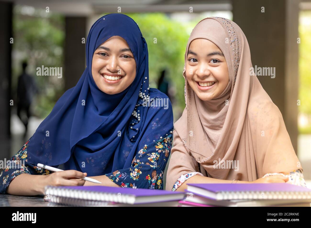 Muslim Student reading book Stock Photo - Alamy