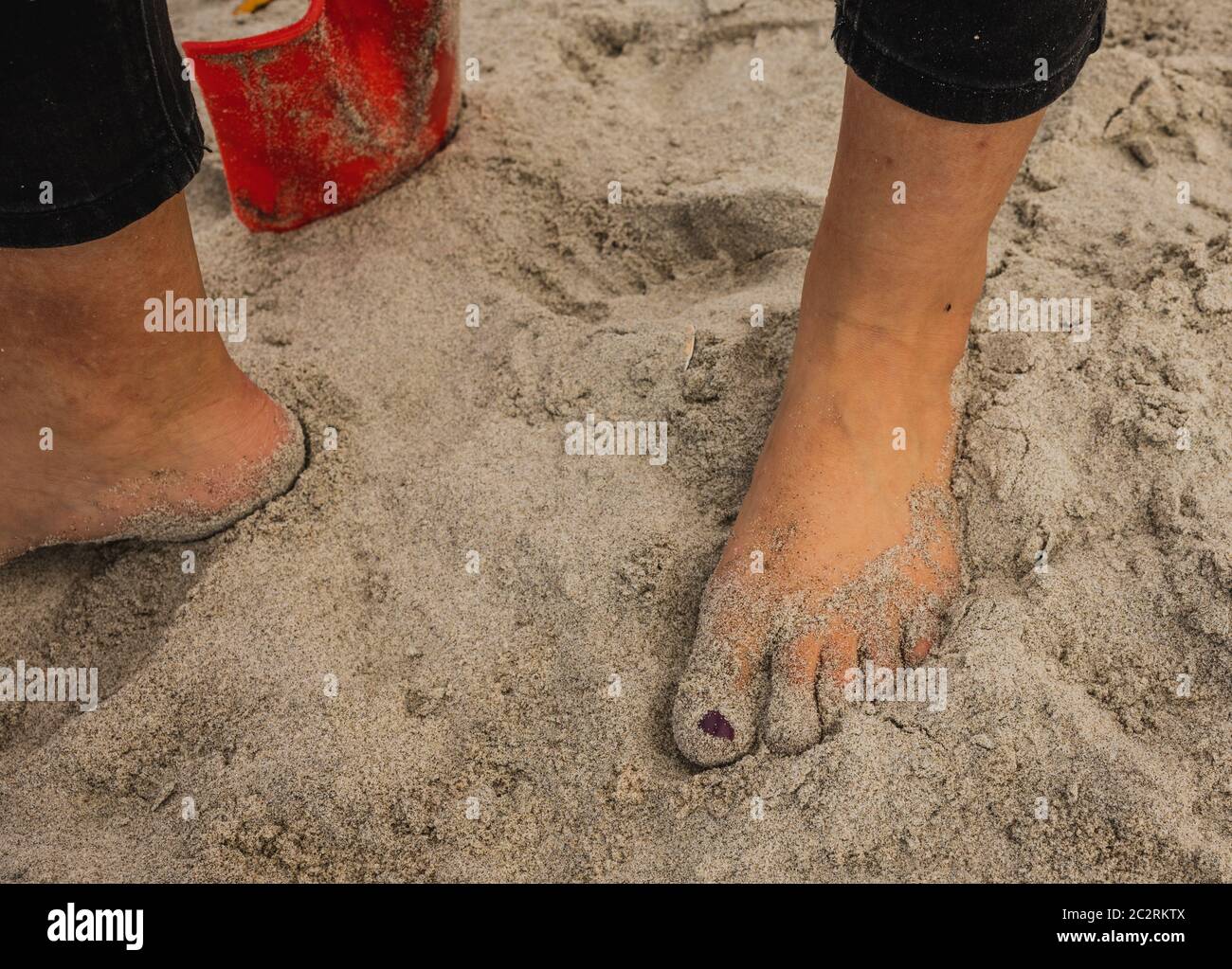 Sandy Feet surrounded by shells on a summers day at the beach Stock ...