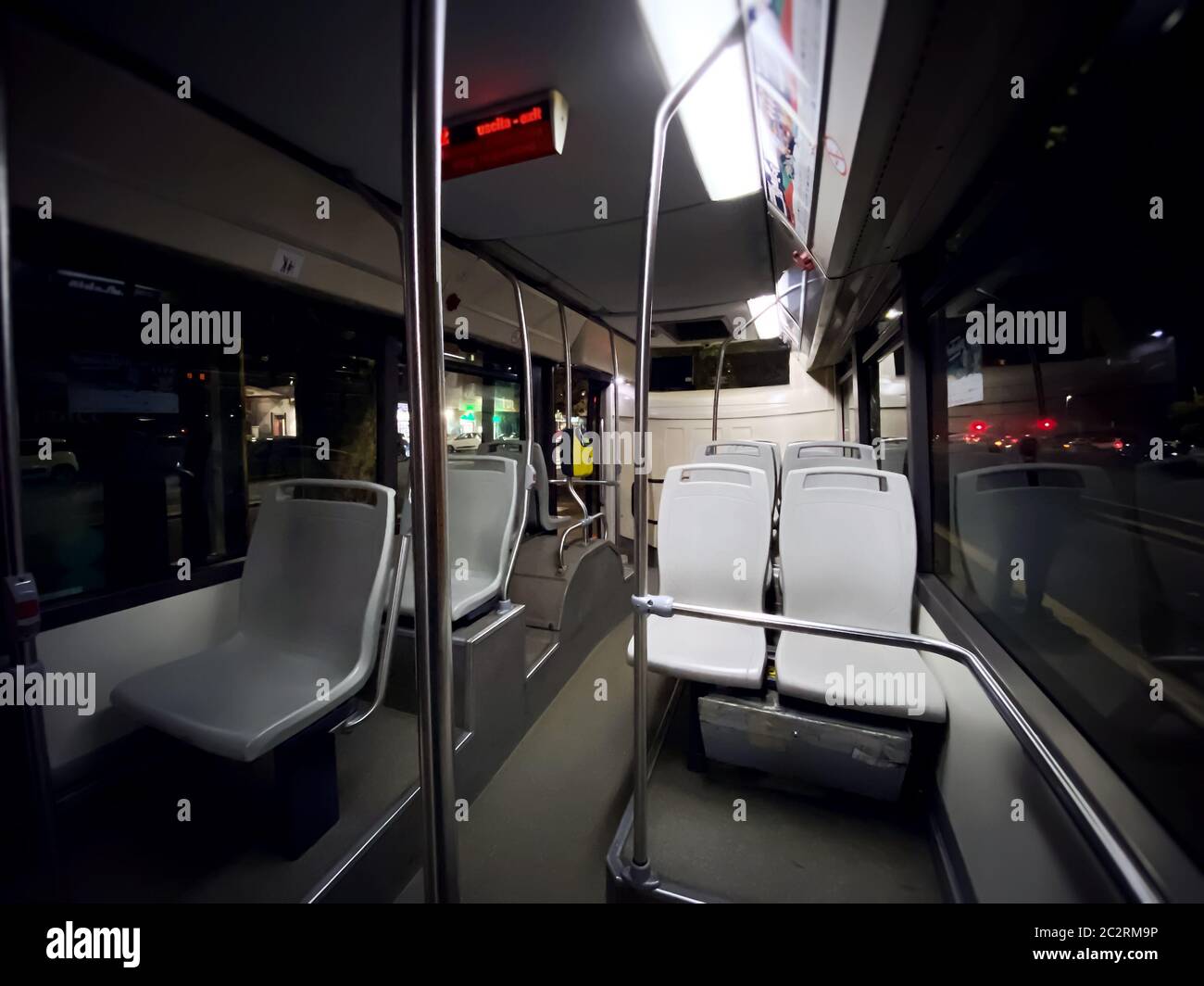 interior of a public transport bus with empty gray seats and no ...