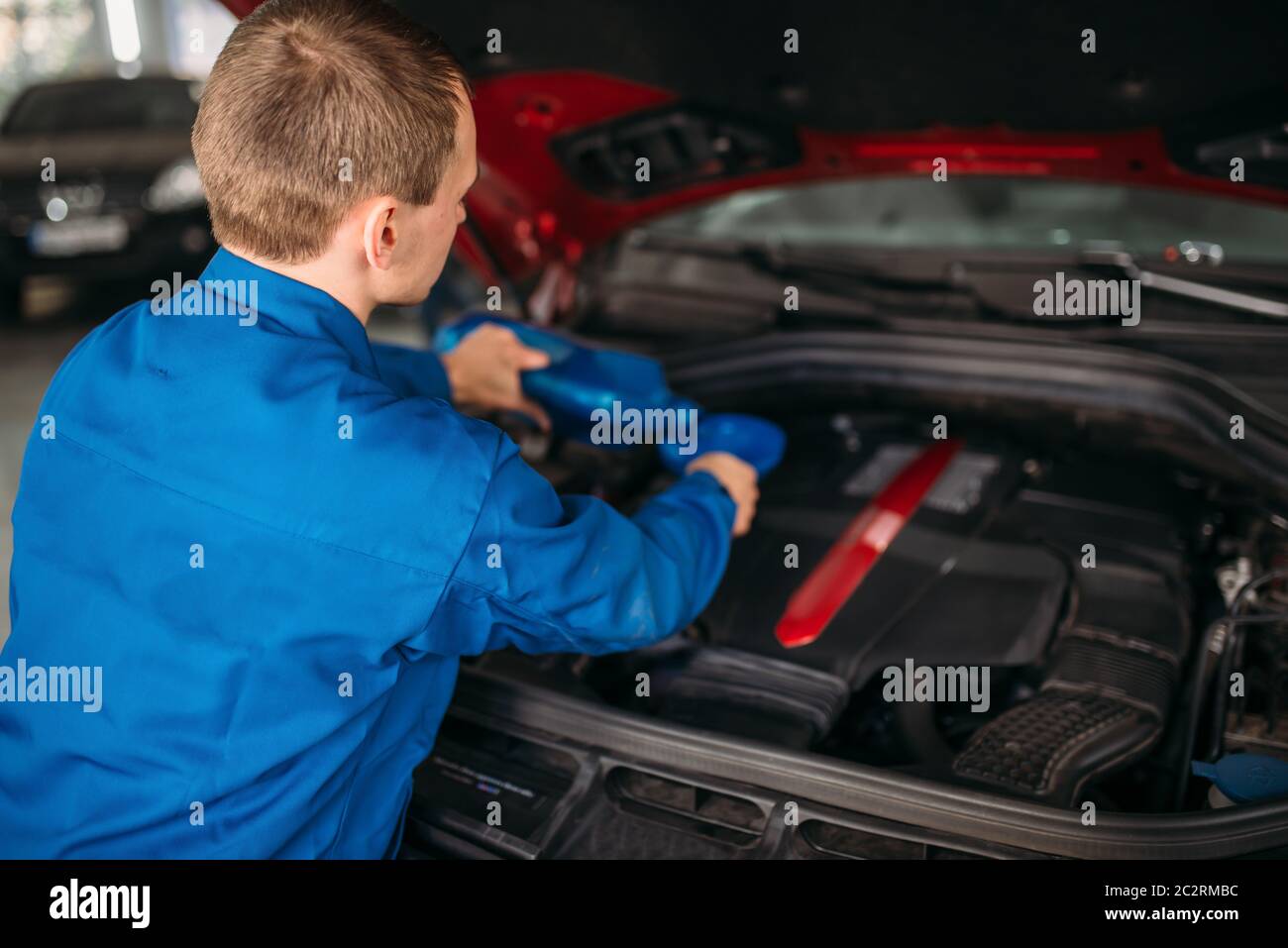 Technician change oil in the car engine. Vehicle motor maintenance ...