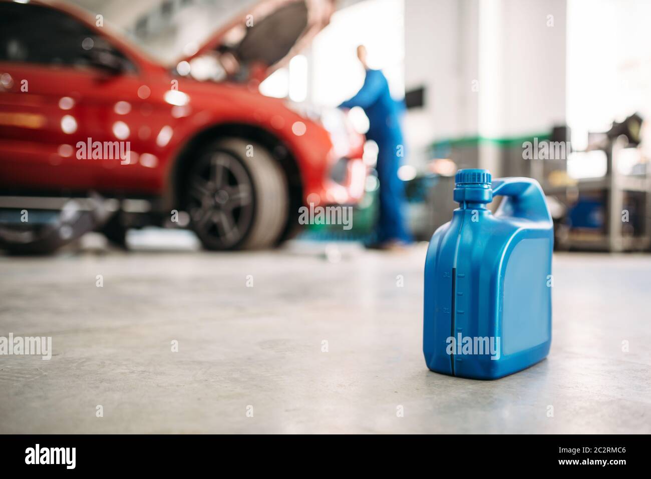 Oil canister on the floor in car service, fluid replacement. Vehicle ...