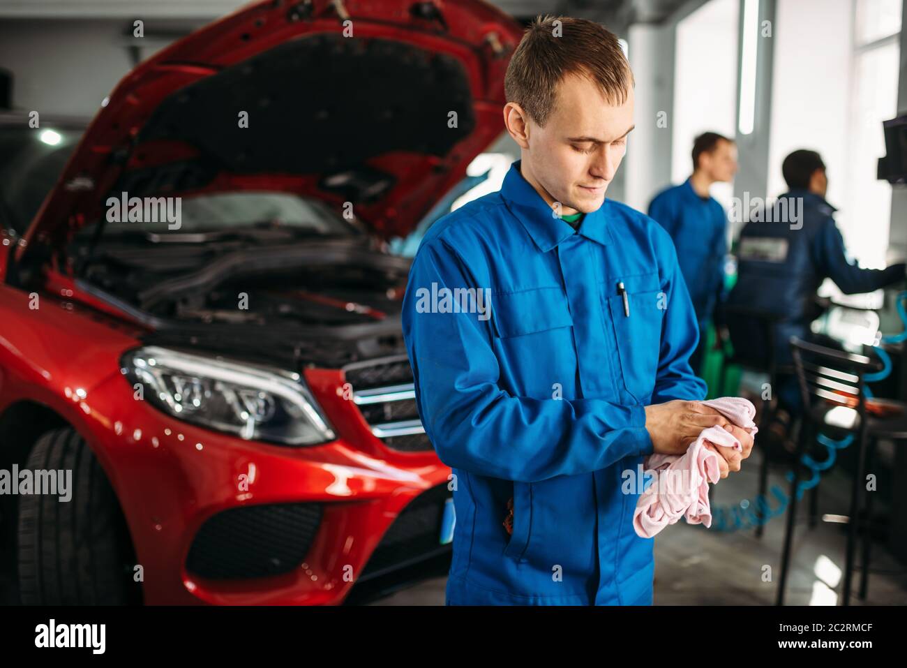 Mechanic wipes his hands after repairing the car, motor diagnostic ...