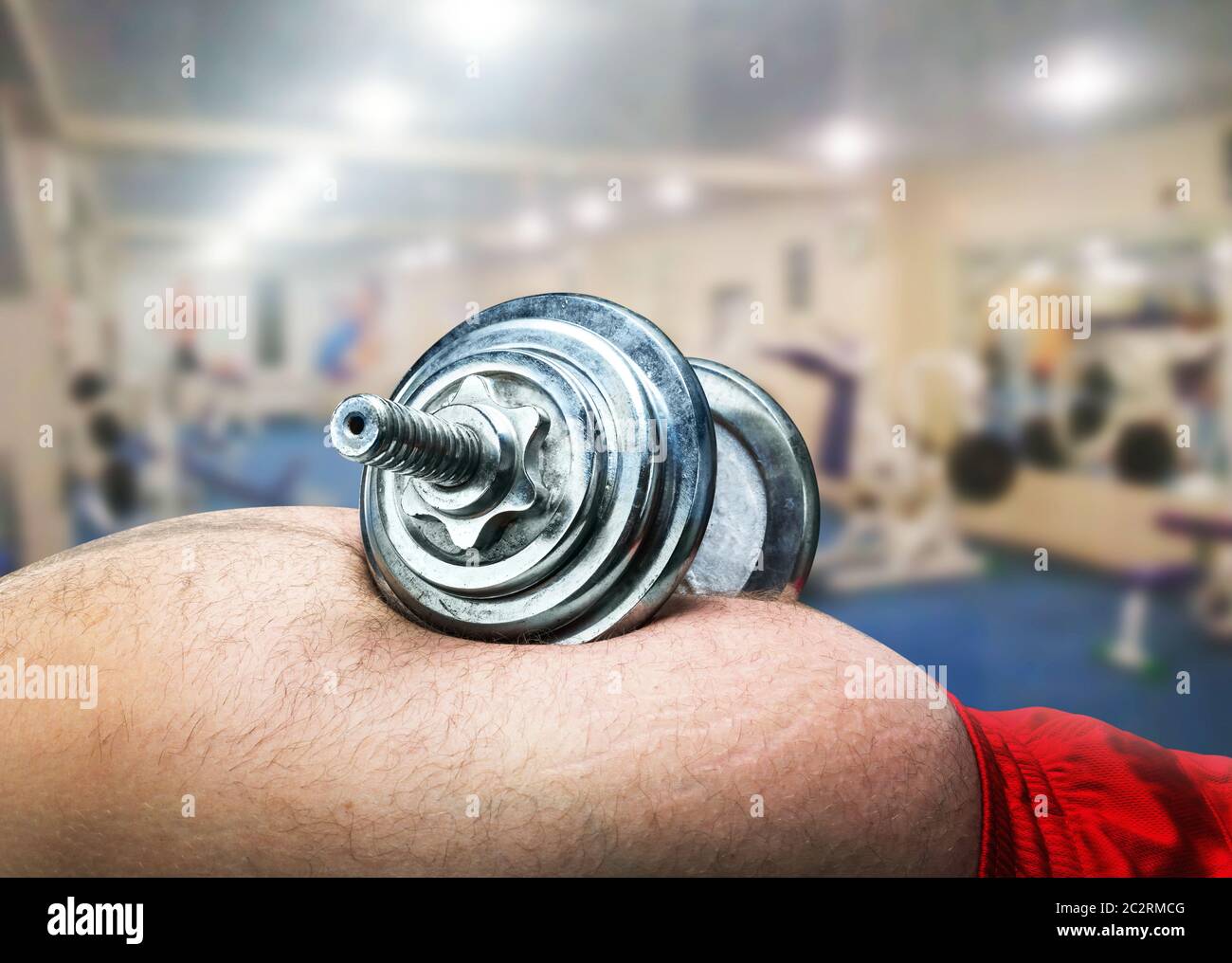Dumbbell lying on fat male belly in the gym Stock Photo - Alamy