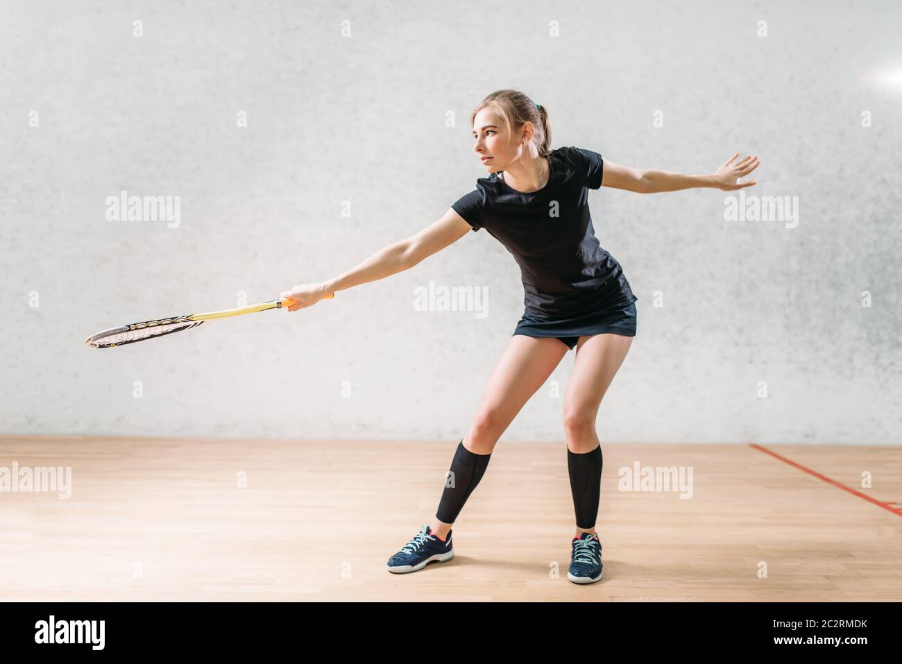 Squash game training, female player with racket in hands, indoor sport ...
