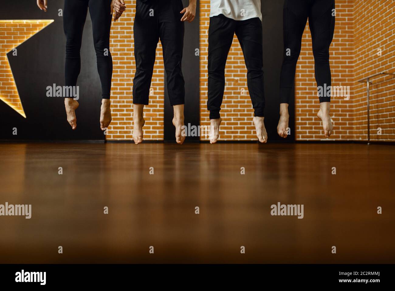 Contemporary dance studio, performers legs in jump. Female and male ...