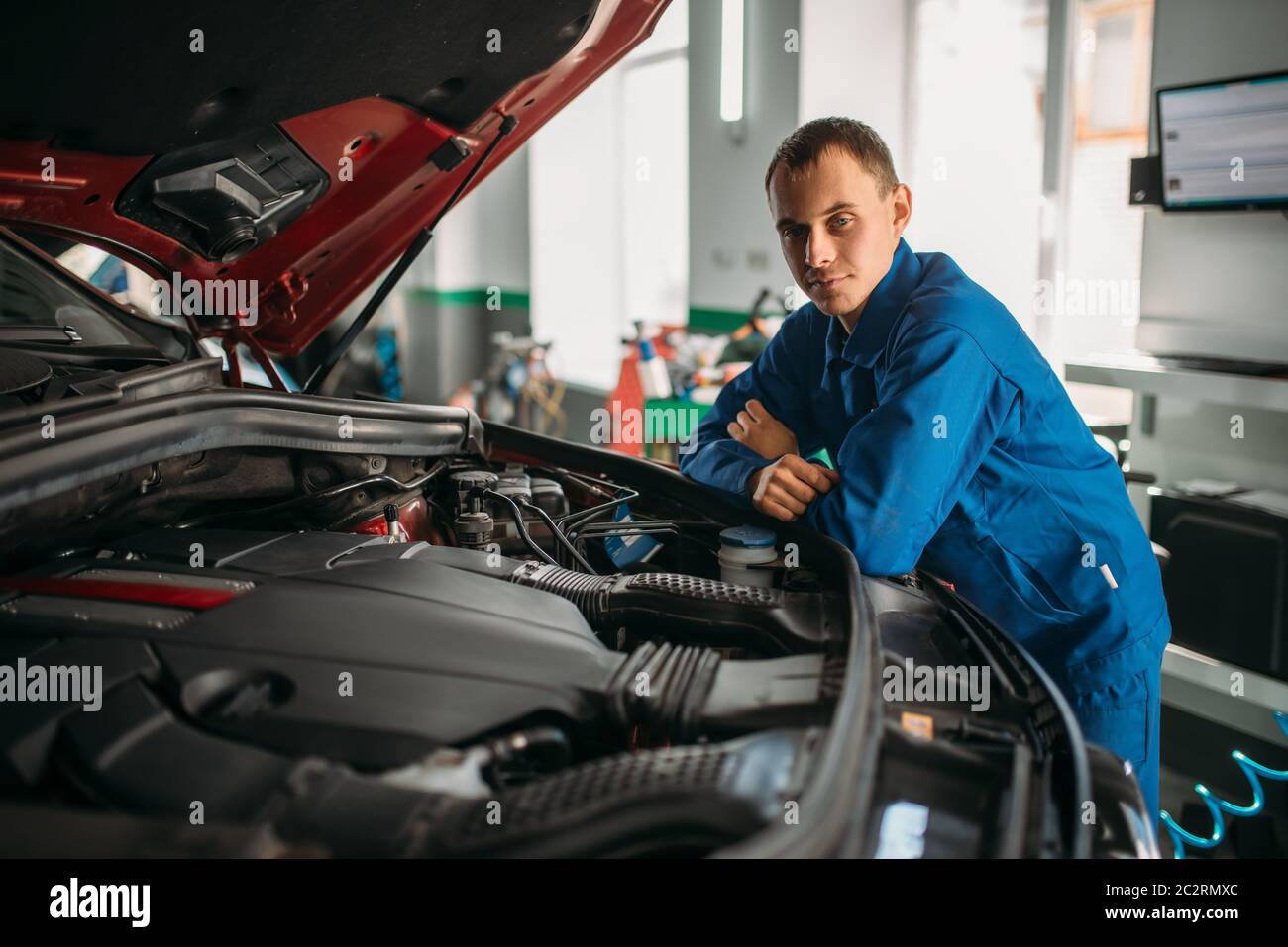 Mechanic makes visual inspection of the car engine, motor diagnostic ...