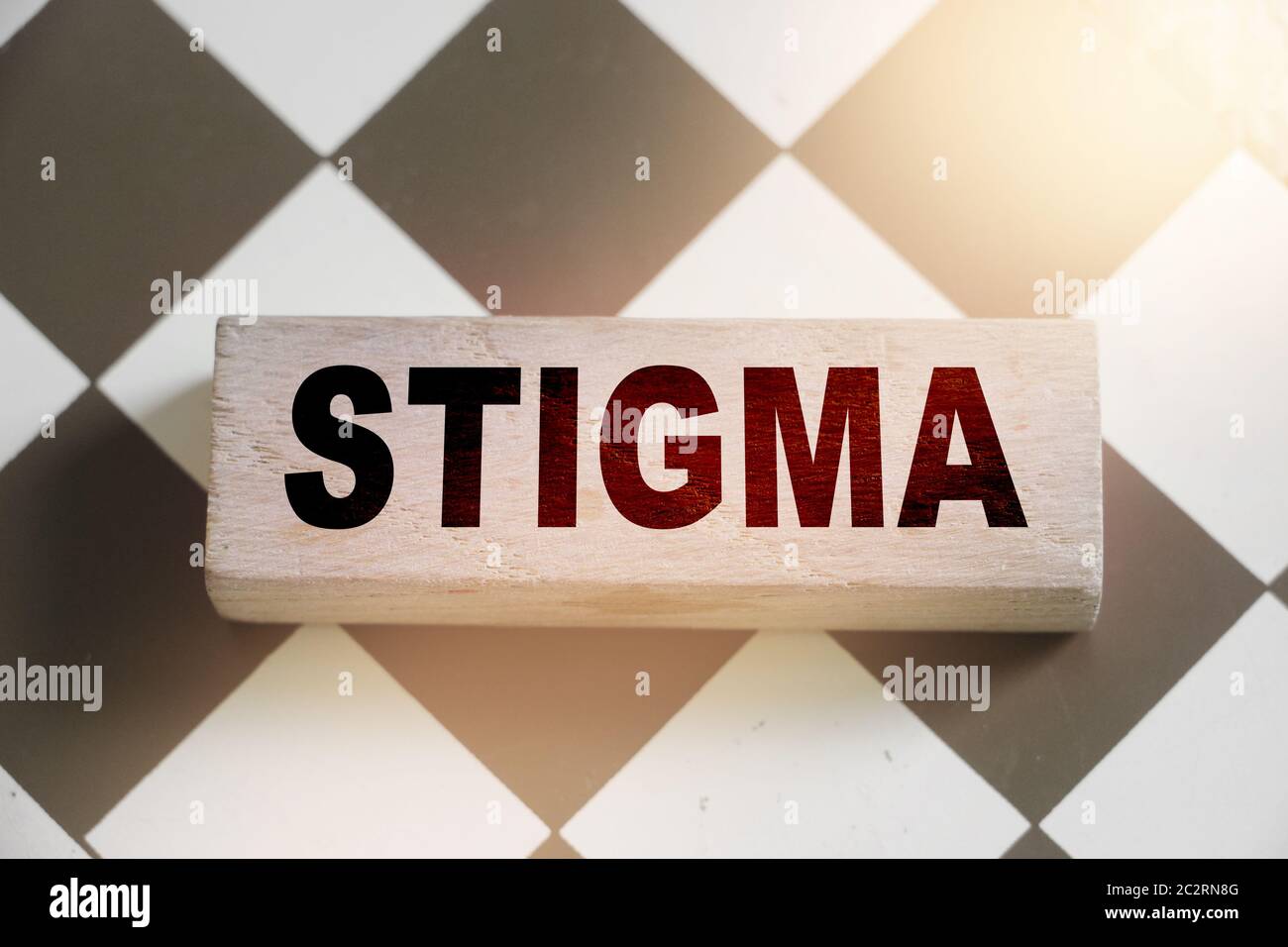 STIGMA word on wooden building block put on chessboard. Discrimination ...