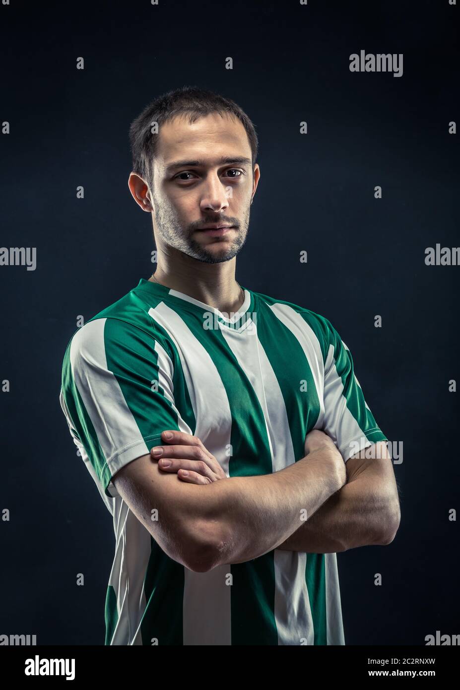 Portrait of confident Football player with crossed arms Stock Photo - Alamy
