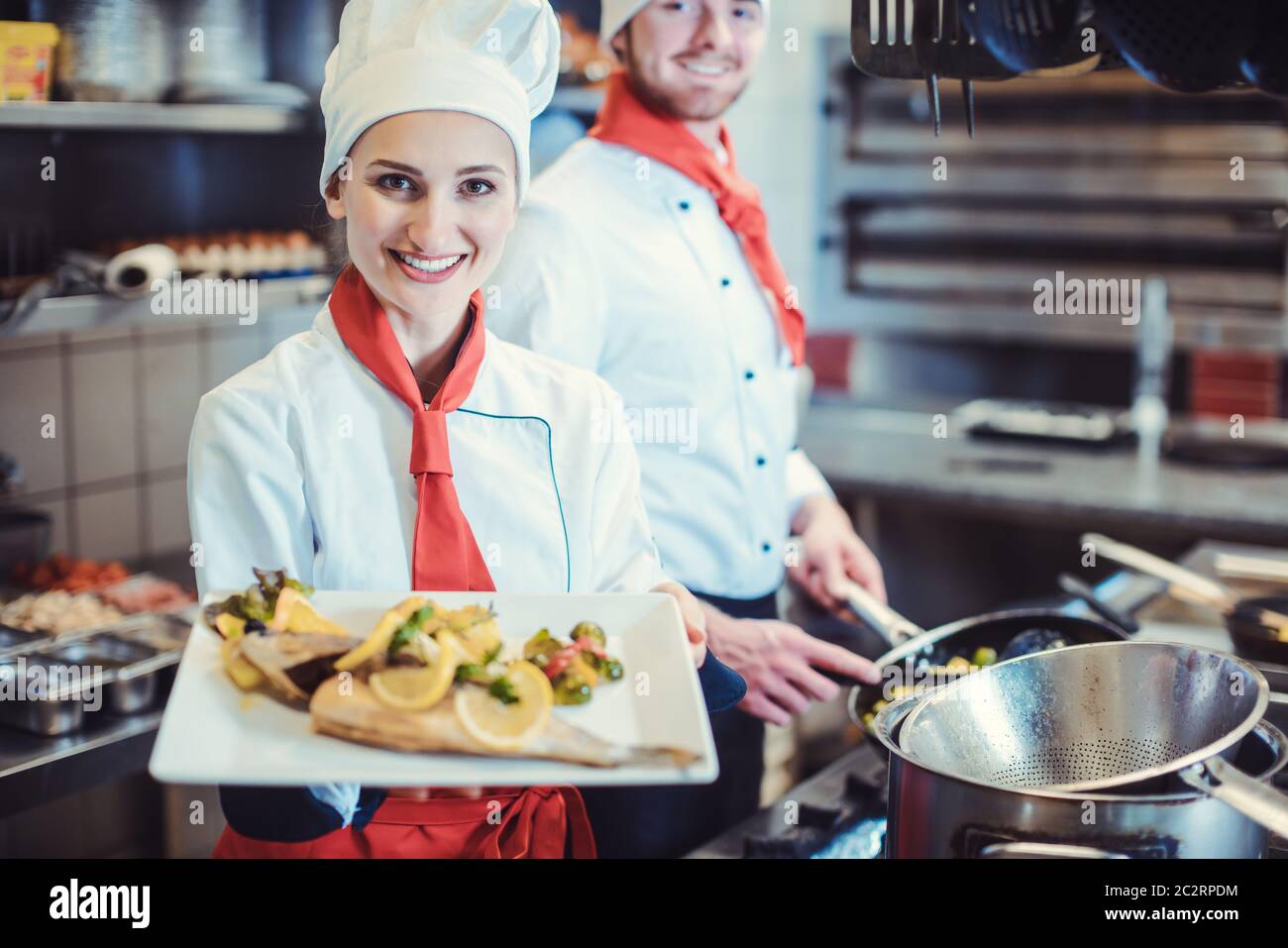 Two chefs presenting dishes hi-res stock photography and images - Alamy