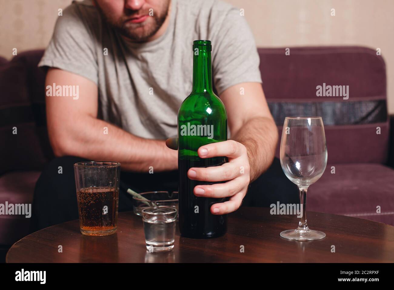 Anonymous alcoholic person hard drinking alone Stock Photo - Alamy