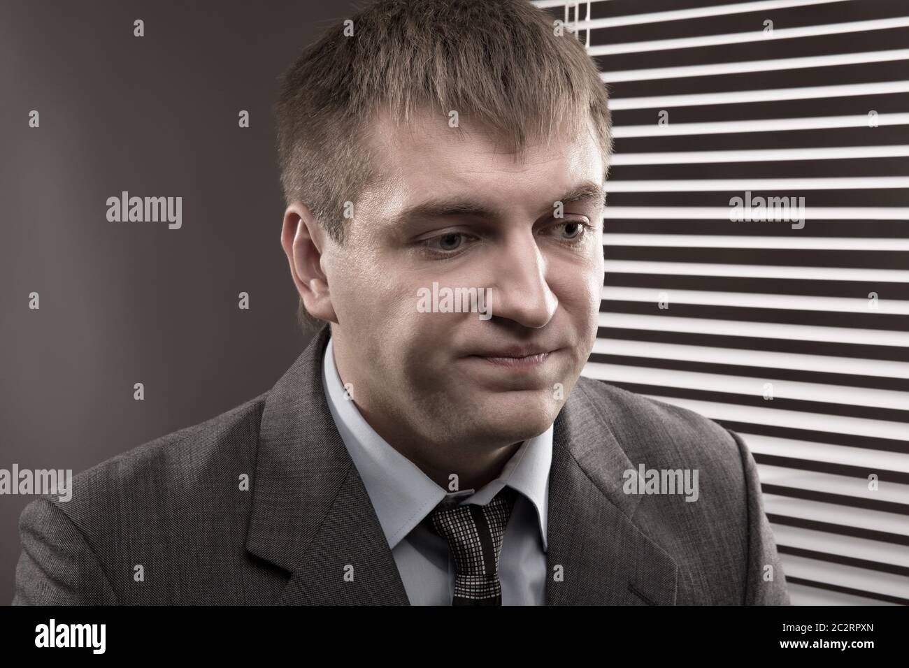 Frustrated young office worker looking down wearily Stock Photo - Alamy