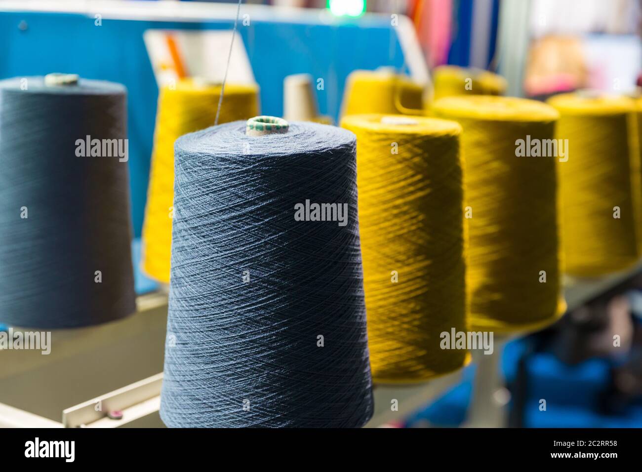 Spools of color threads closeup, sewing equipment. Cloth factory ...