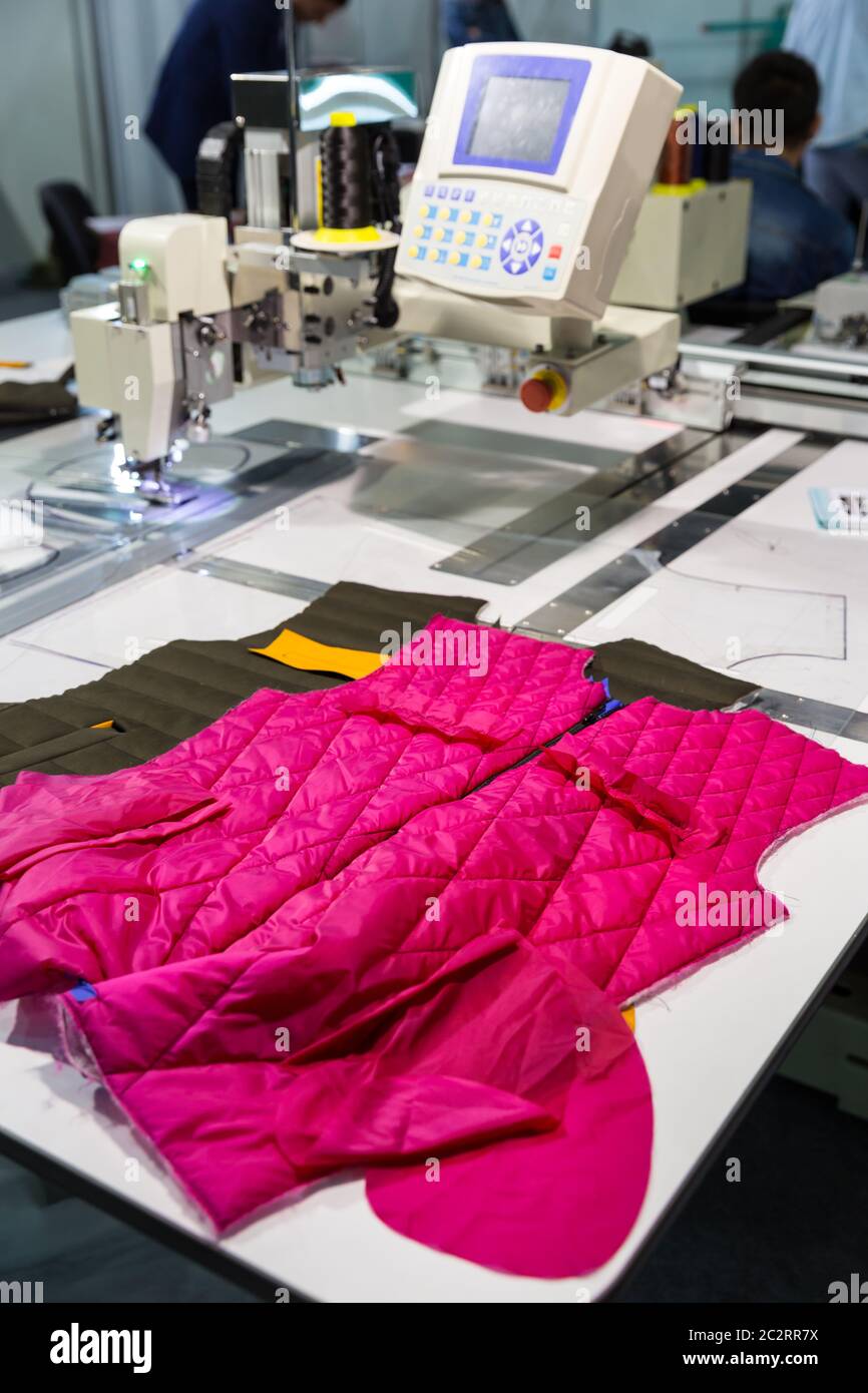 Sewing machine in cutting shop on clothing factory, nobody. Fabric ...