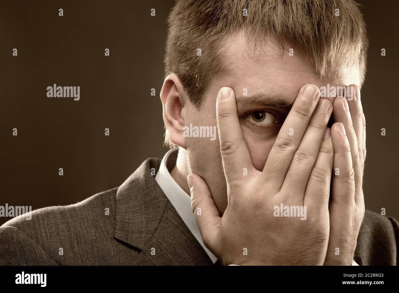 Tired office worker in a suit staring pensively Stock Photo - Alamy