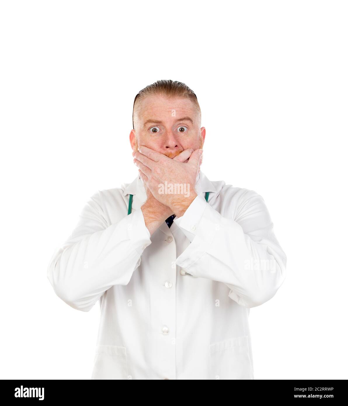 Embarrassed redhead doctor covering his mouth isolated on a white ...