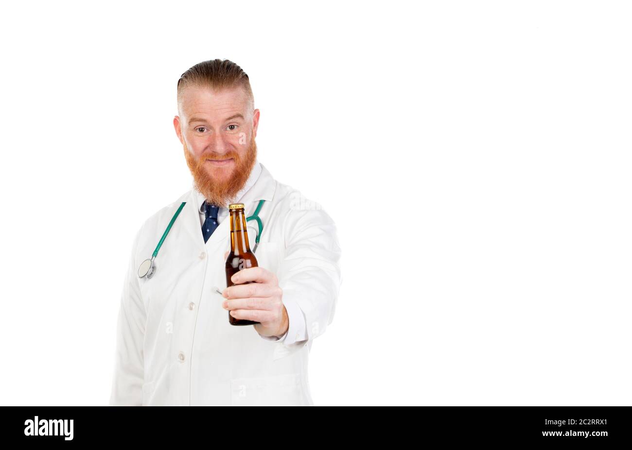 Redhead doctor with a bottle of beer isolated on a white background ...