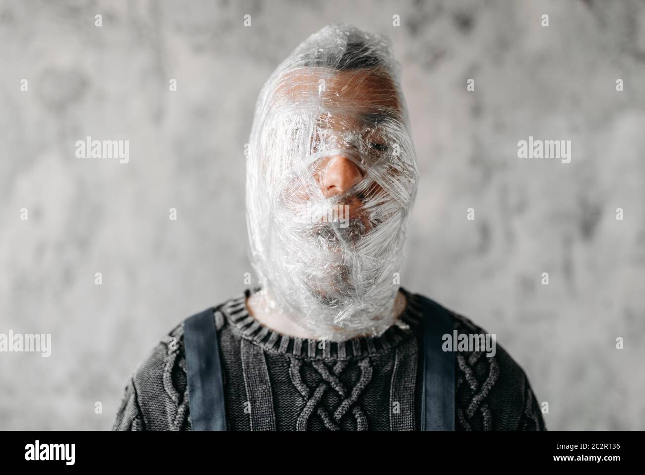 Depressed autistic wraps his head in packaging film, autism syndrome ...