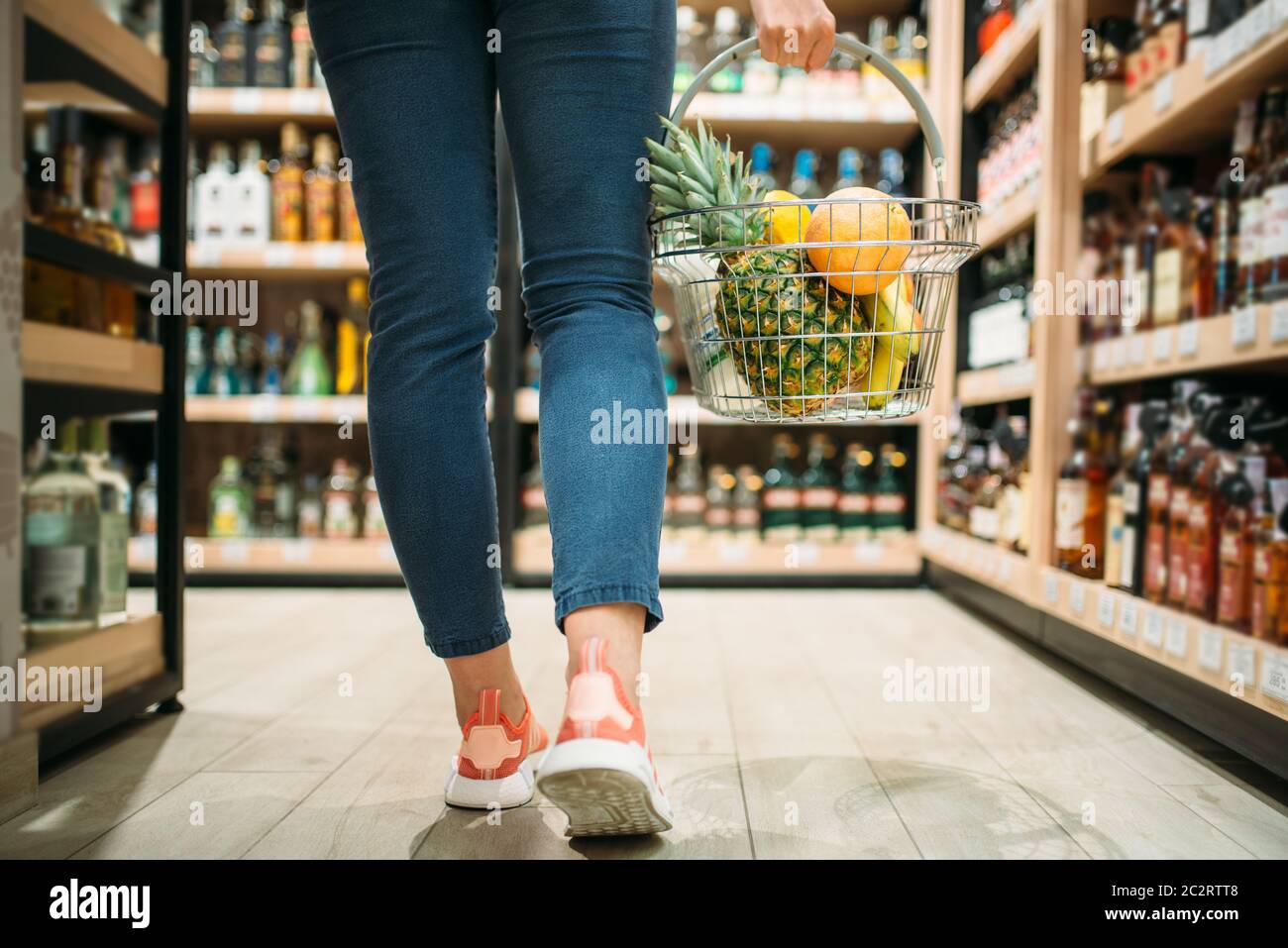 Female customer choosing products in supermarket. Woman in food store ...