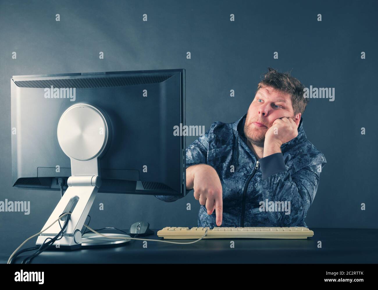 Fat boring man sitting at desk looking at monitor screen Stock Photo ...