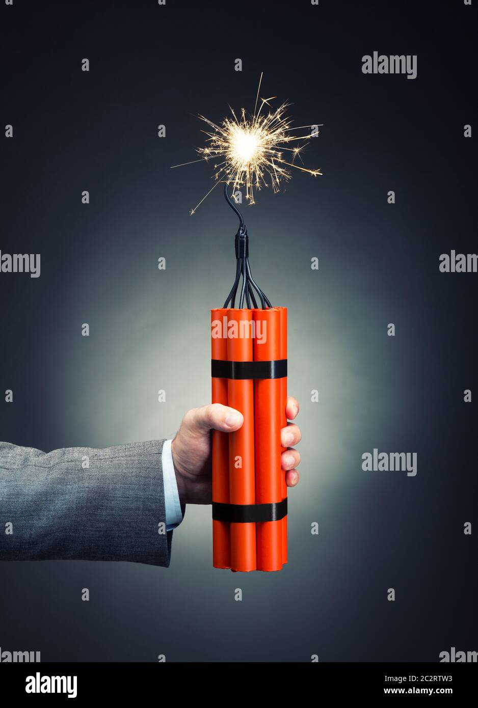 Hand holding dynamite with burning wick Stock Photo - Alamy