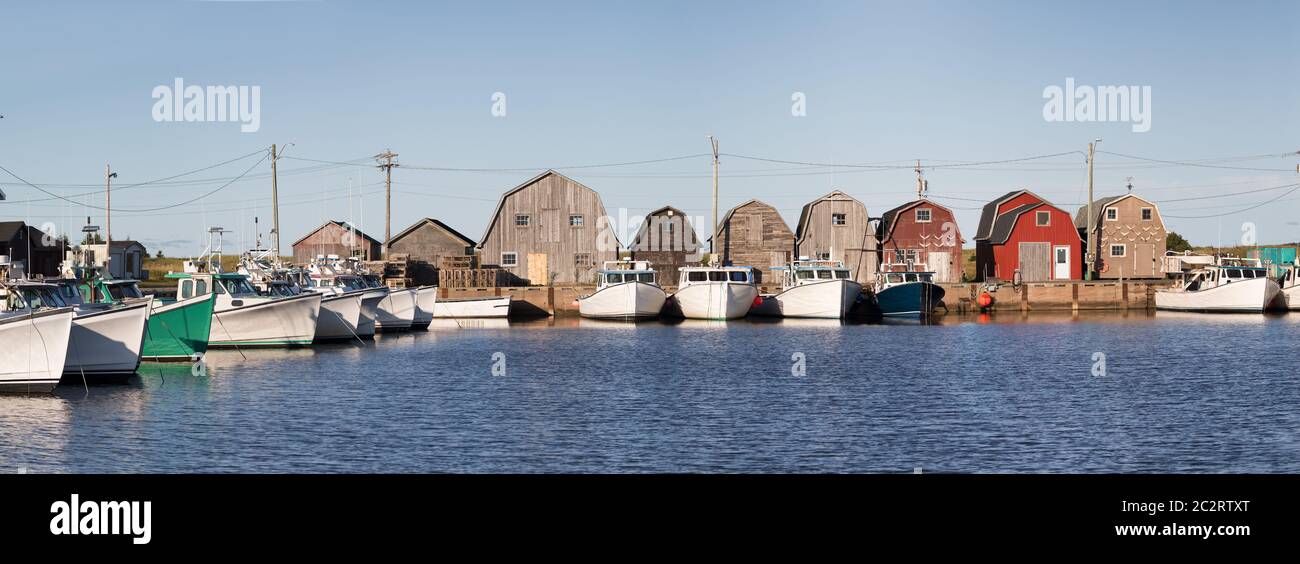 Panorama of a row of Oyster barns and fishing boats at Malpeque Harbour ...