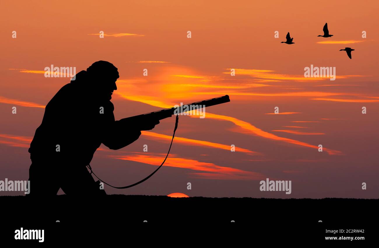 Silhouette of men on the hunting Stock Photo - Alamy