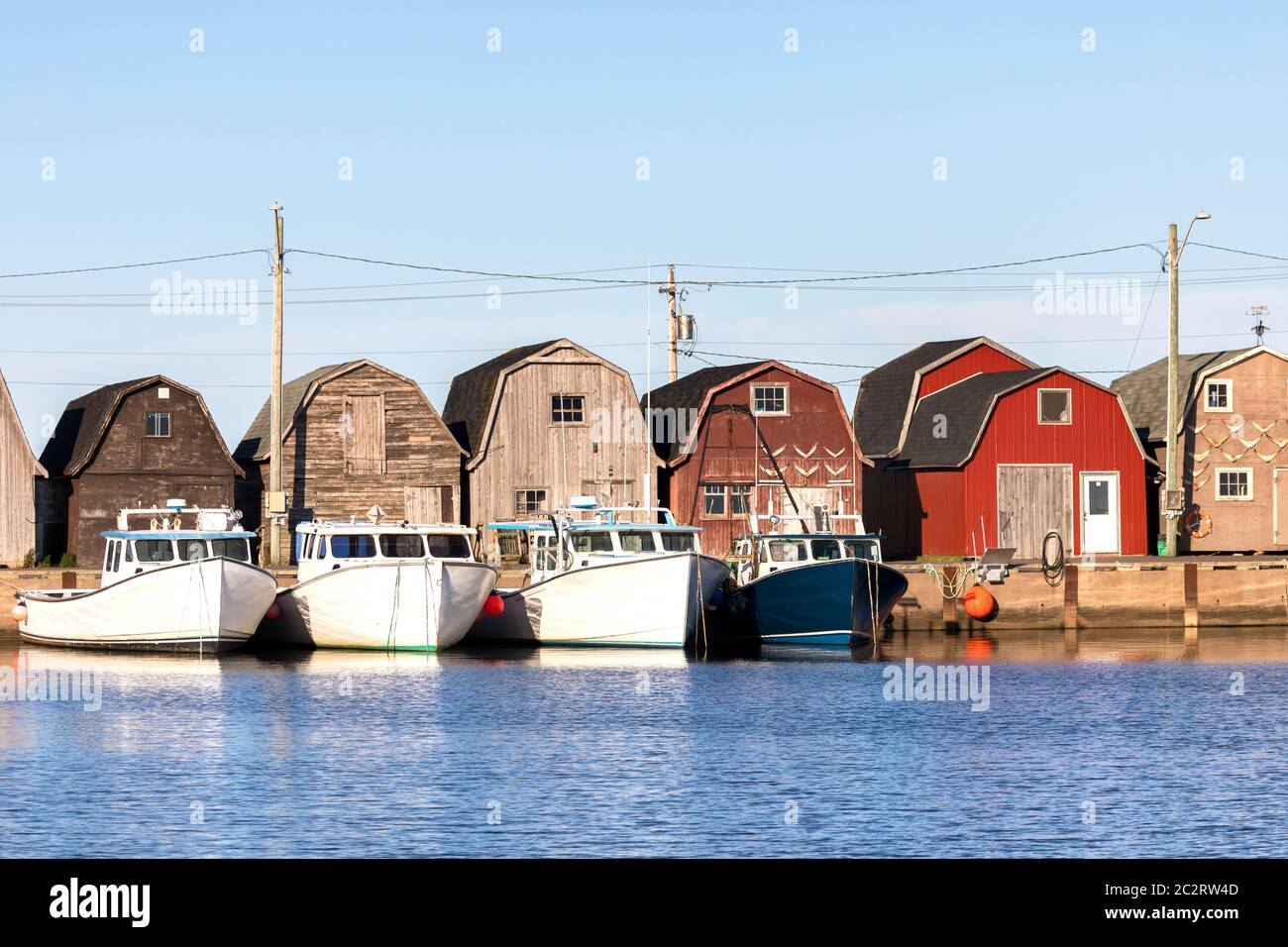 A line of Oyster barns and fishing boats at Malpeque Harbour on the ...