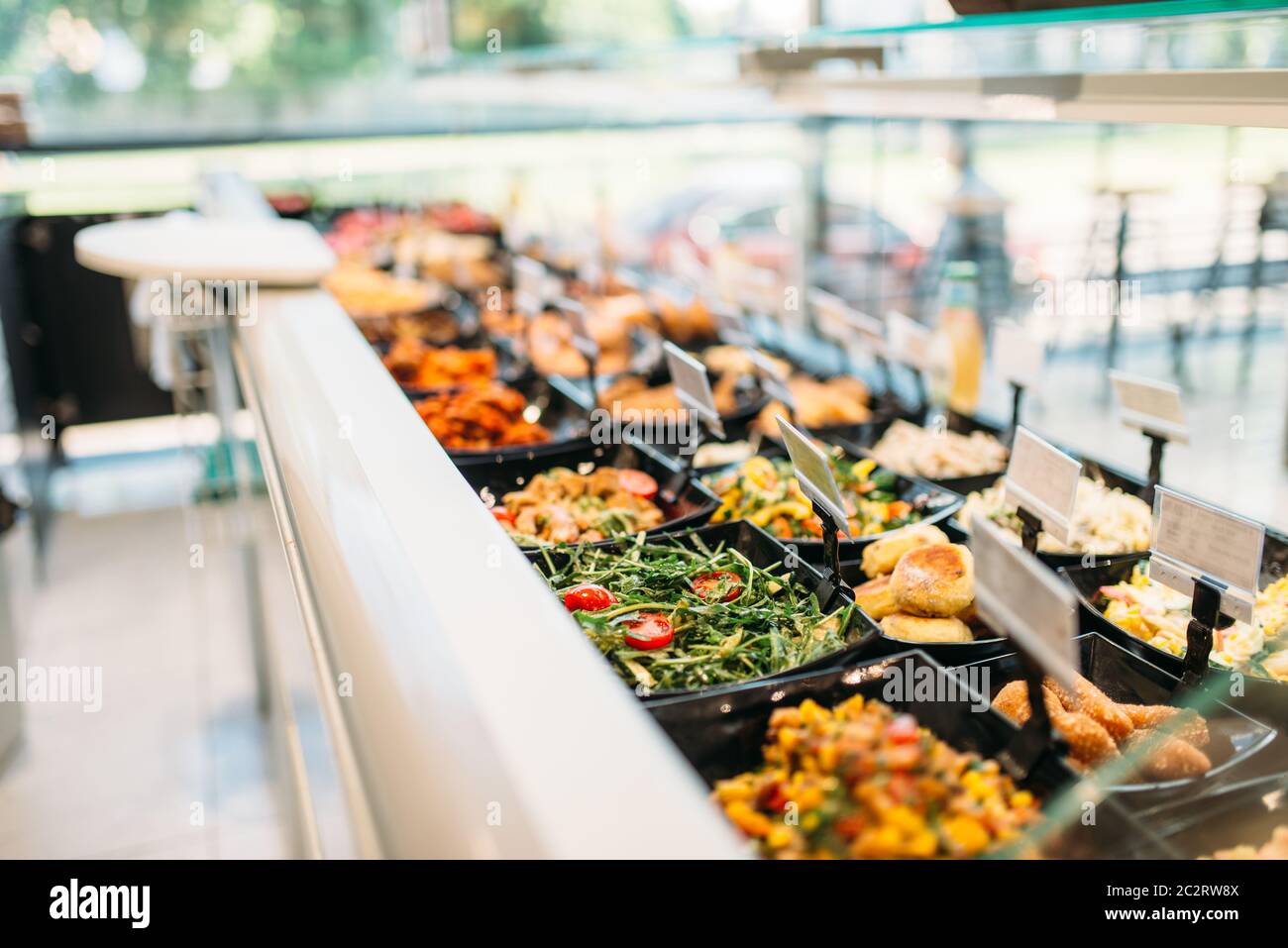 Fresh cooked food in store, nobody. Showcase with prepared salads and ...