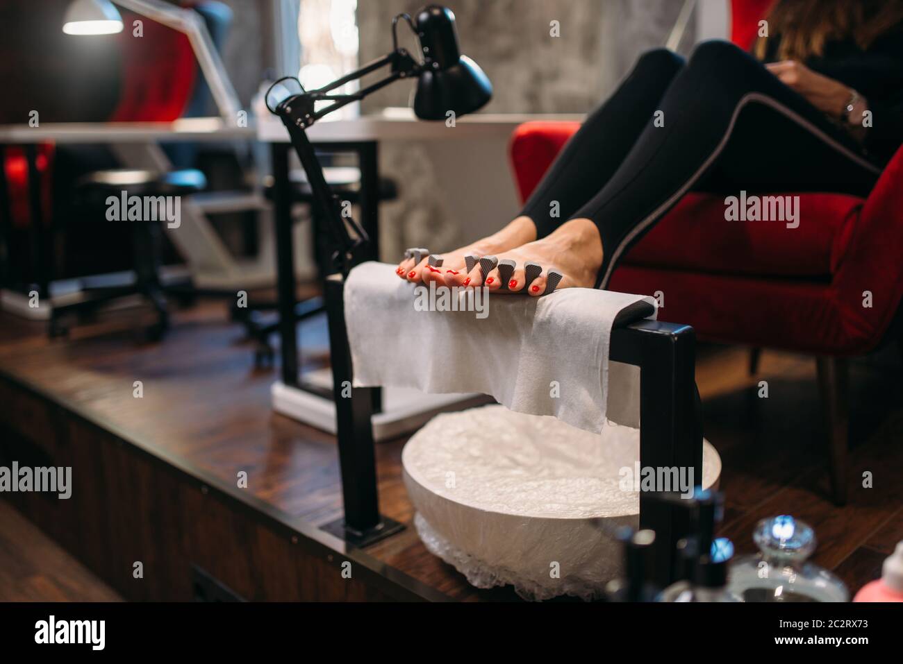 Female client on pedicure cosmetic procedure in beauty salon ...