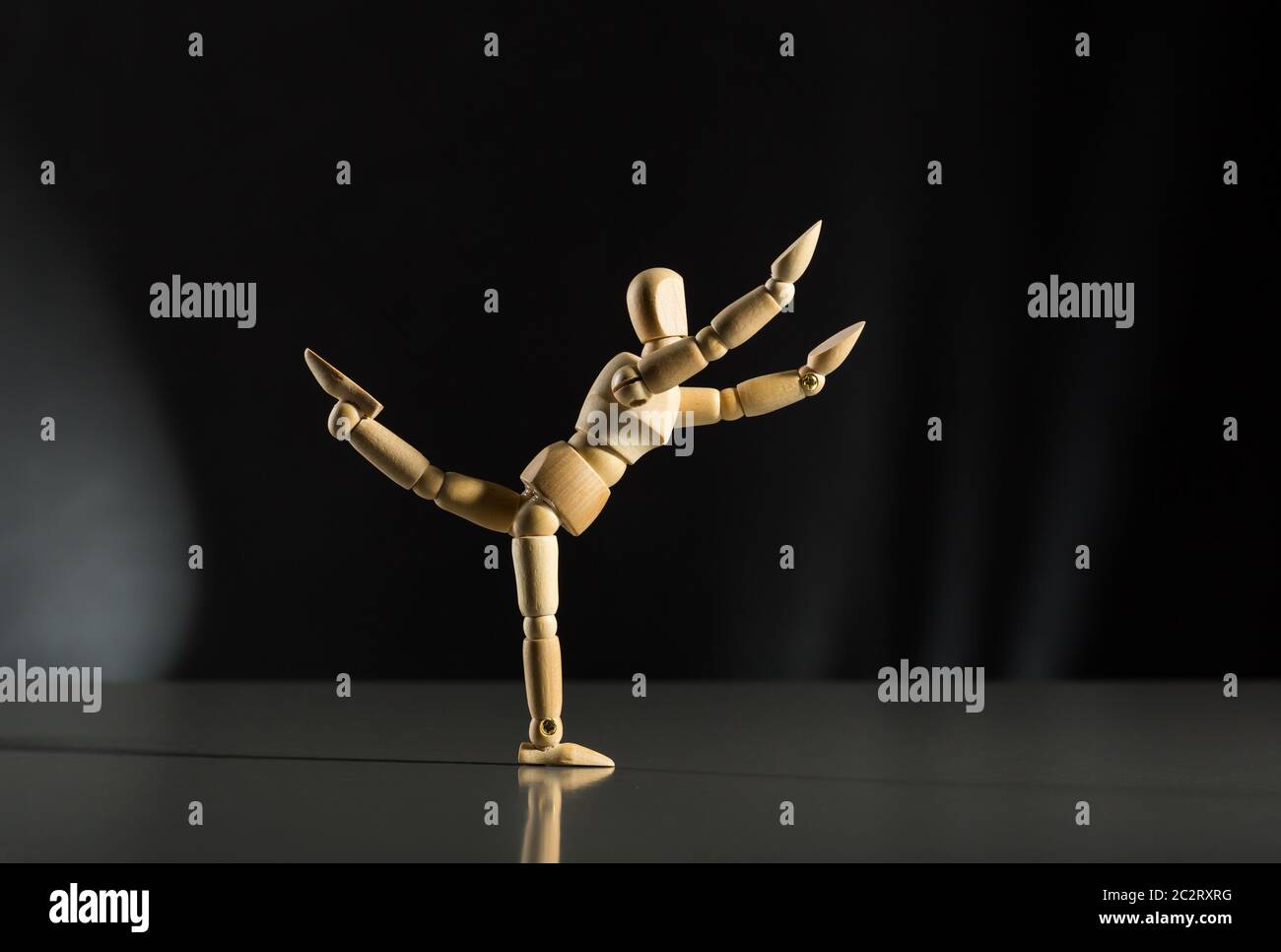 Human wood manikin is dancing against dark background Stock Photo - Alamy