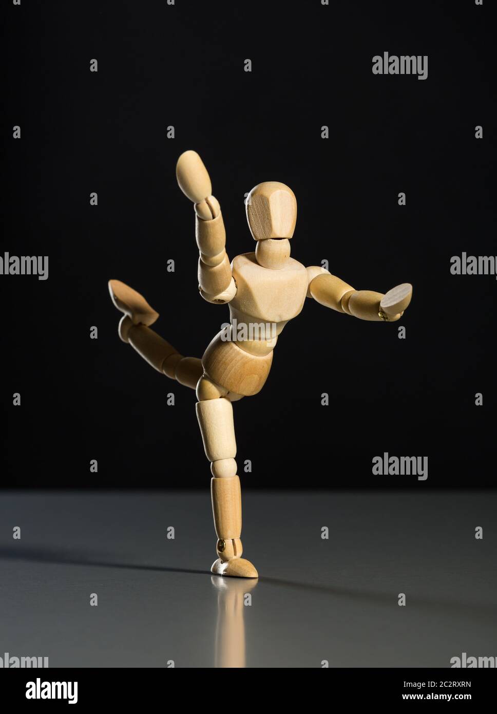 Human wood manikin dancing against dark background Stock Photo - Alamy