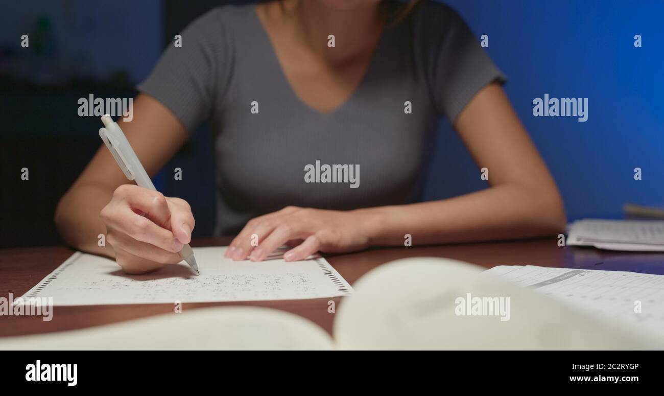 Woman write on the paper at home in the evening Stock Photo - Alamy