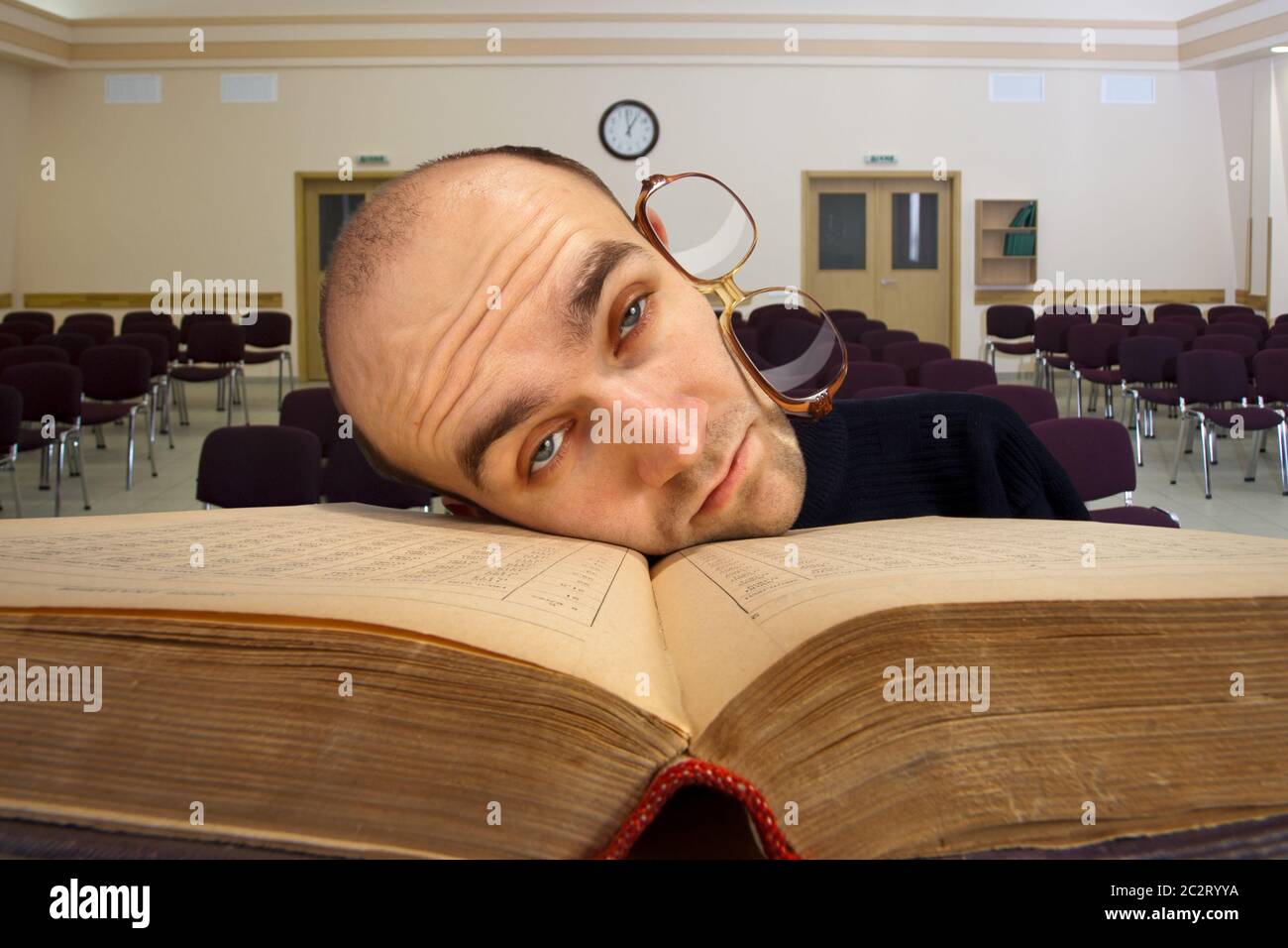Exhausted sleepy student at empty university classroom Stock Photo - Alamy