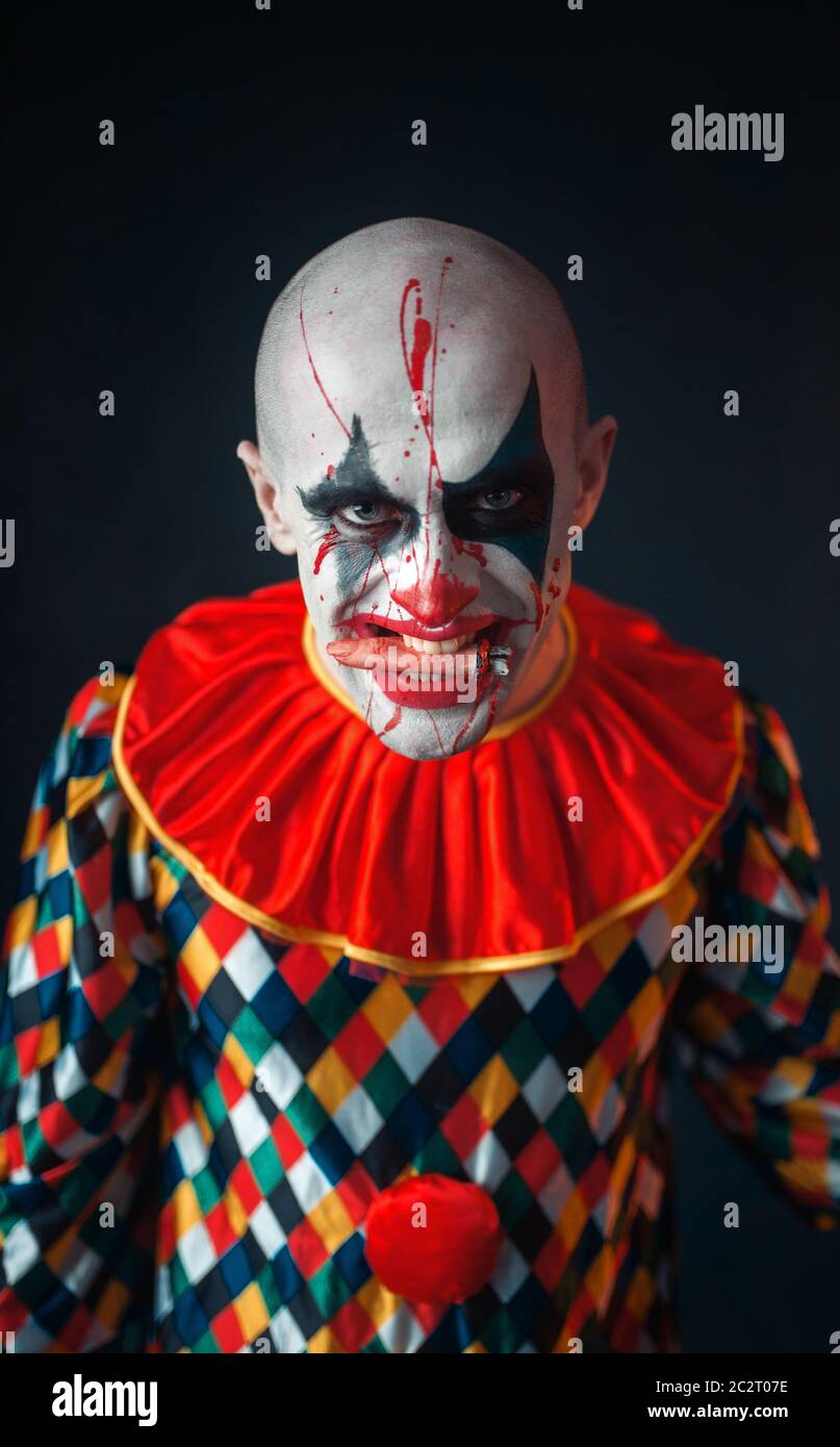 Portrait of mad bloody clown, face in blood. Man with makeup in ...