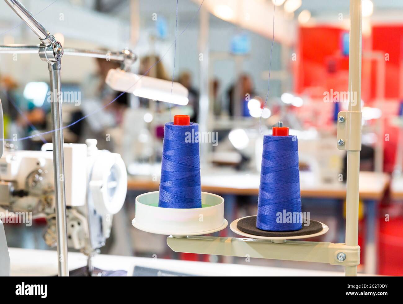 Spools of blue threads on sewing machine. Cloth factory, weaving ...