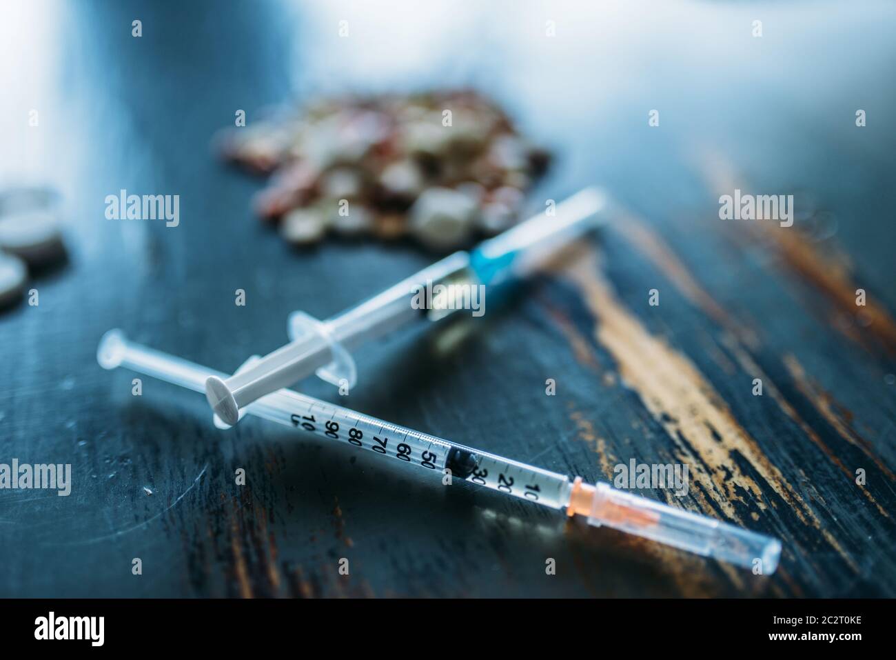 Addict kit, narcotics concept, addiction problem. Pills are laid out on ...