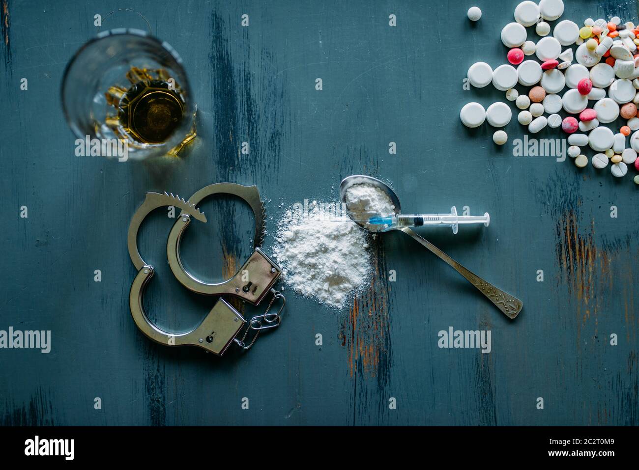 Drug user kit, narcotics concept, addiction problem. Pills are laid out ...