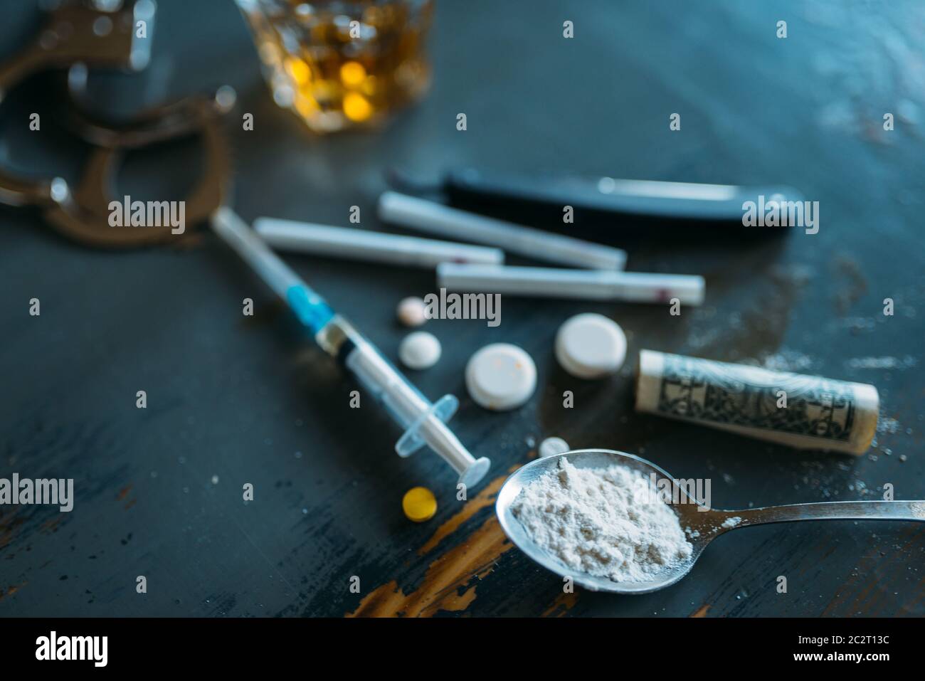 Druggy kit, dose in spoon, addiction problem concept. Pills are laid ...