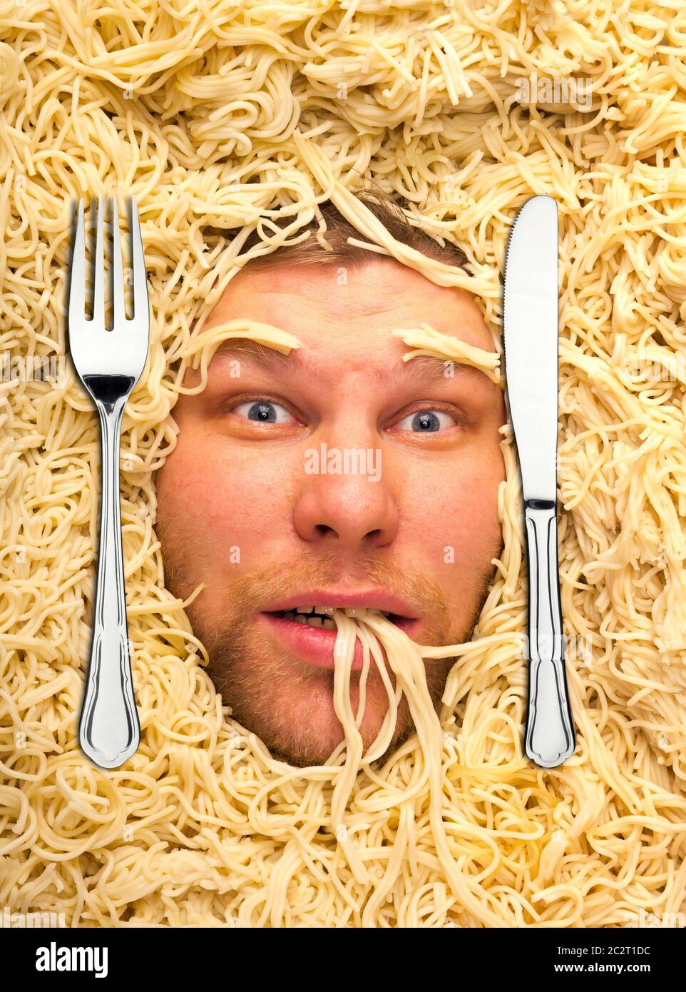 Man lying in pasta, dinner time Stock Photo - Alamy