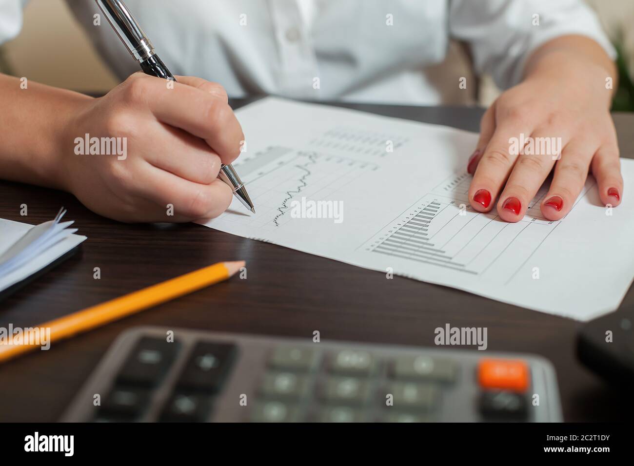 Bookkeeper signs accounting balance sheet. Accountant hands closeup ...
