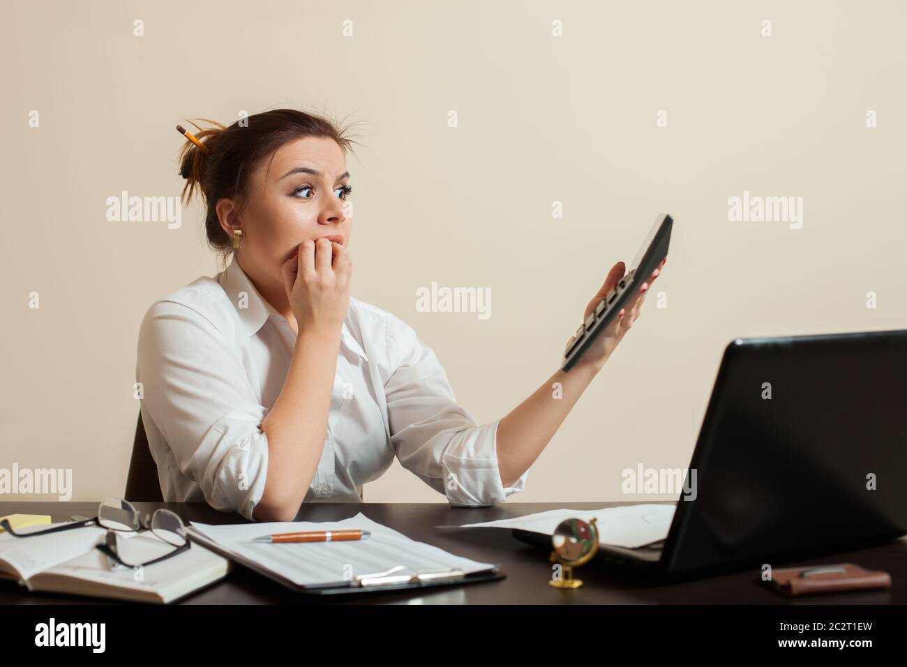 Scared female bookkeper looks at the accounting balance sheet Stock ...