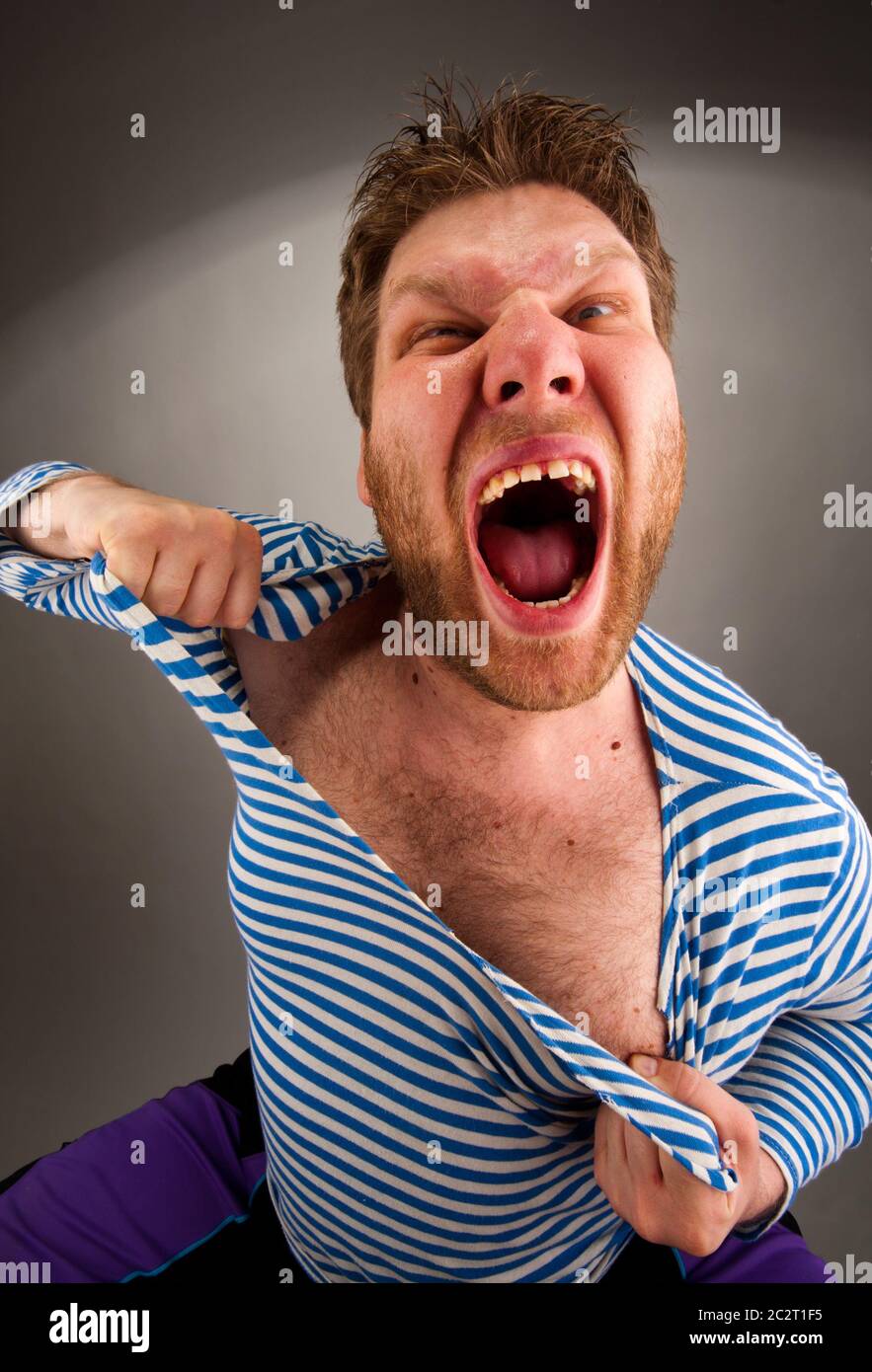 Angry prisoner bandit tearing clothing on himself Stock Photo - Alamy