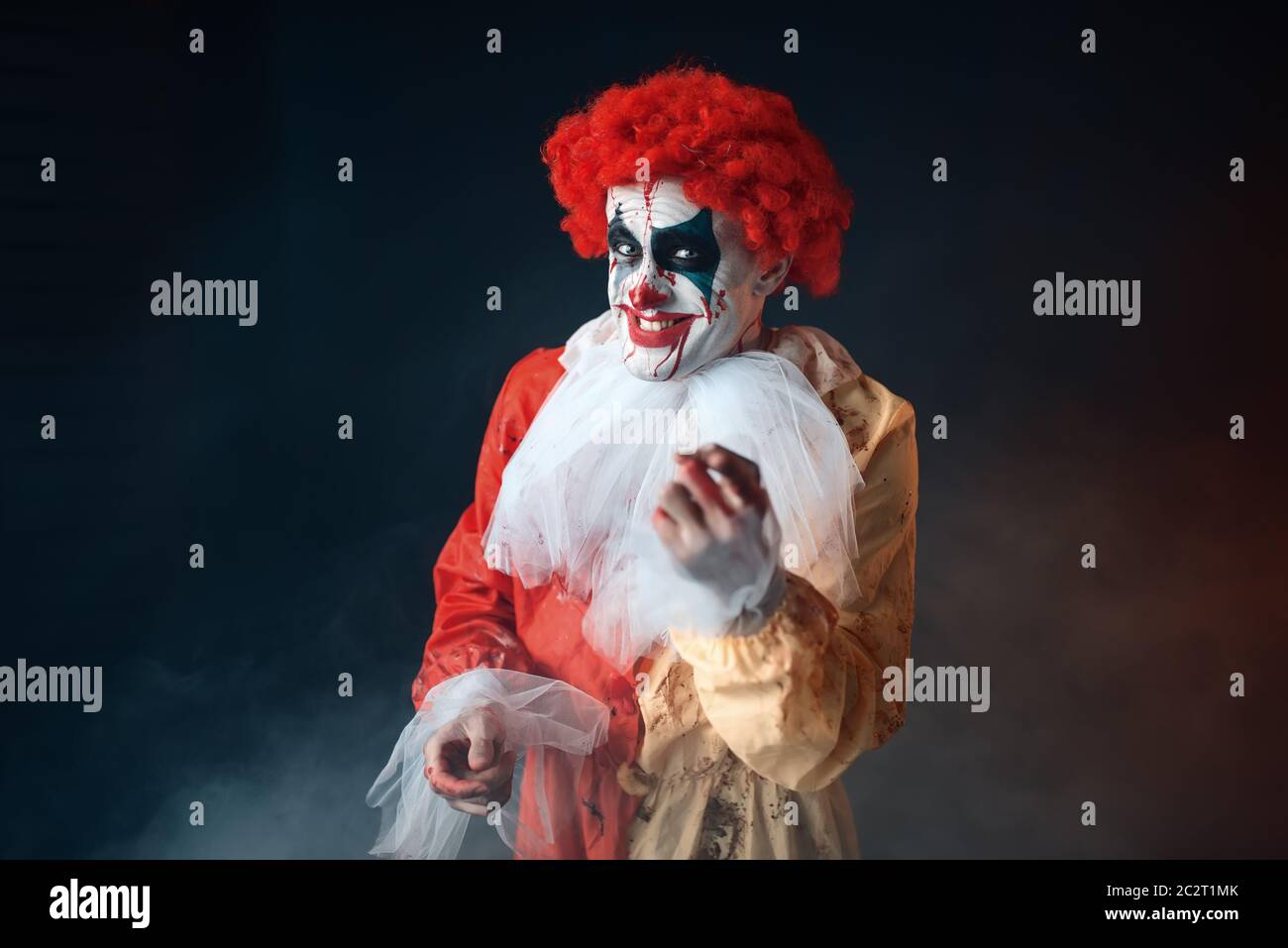 Portrait of scary bloody clown with crazy eyes. Man with makeup in ...