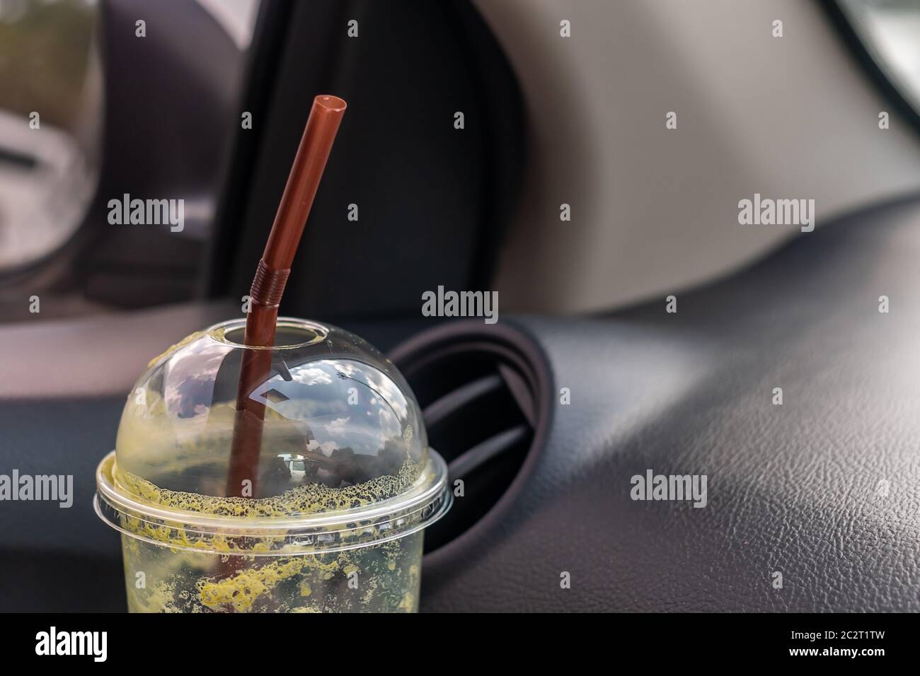 Ice milk green tea famous drink in a car blurred background Stock Photo ...