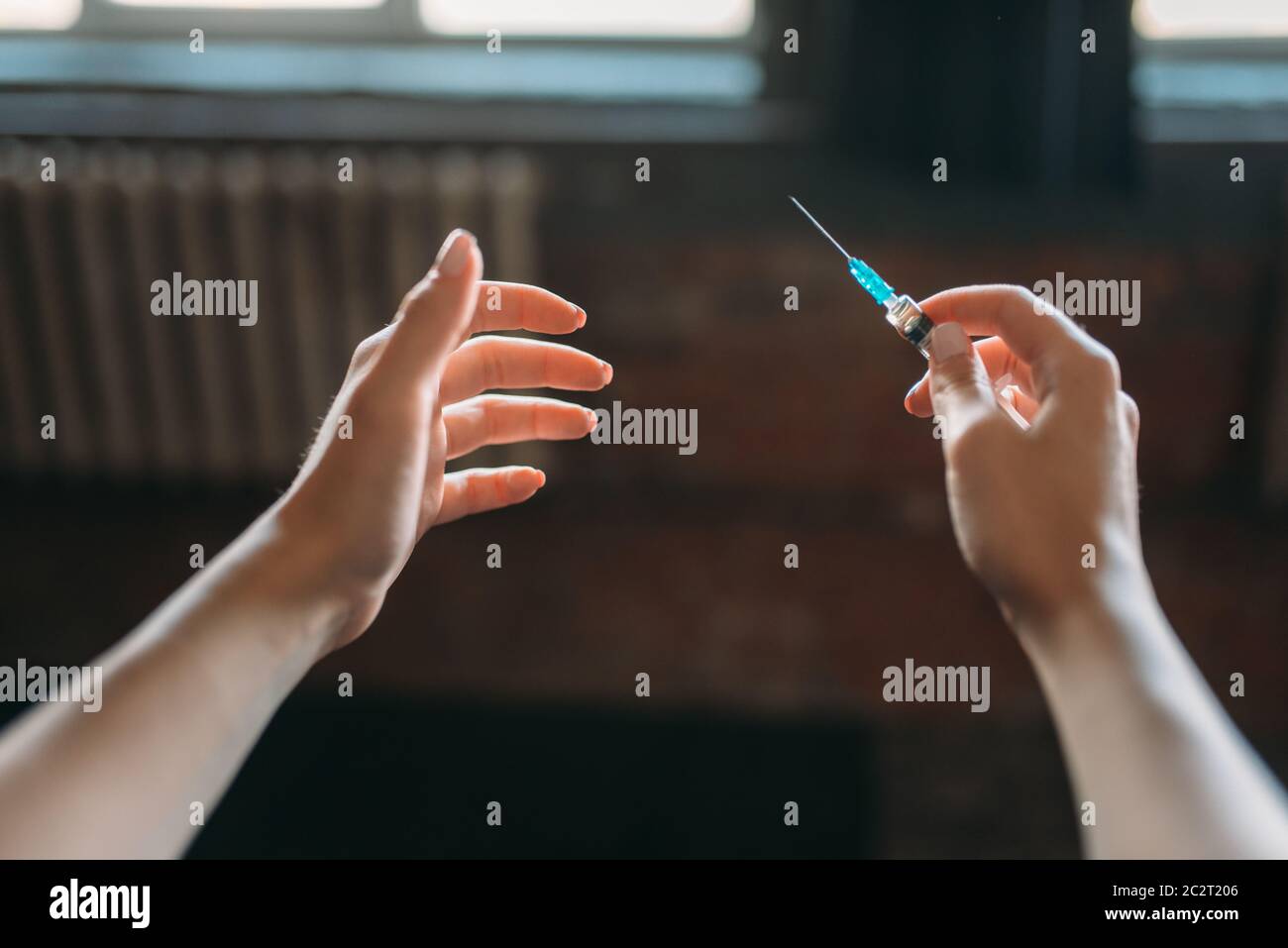 Female junkie hands with syringe, grunge room interior on background ...