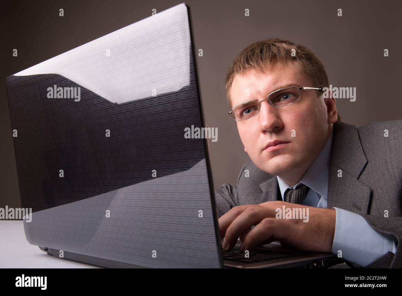 A young office worker working till late Stock Photo - Alamy