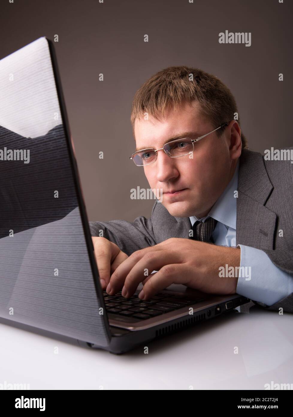 A young office worker working till late Stock Photo - Alamy