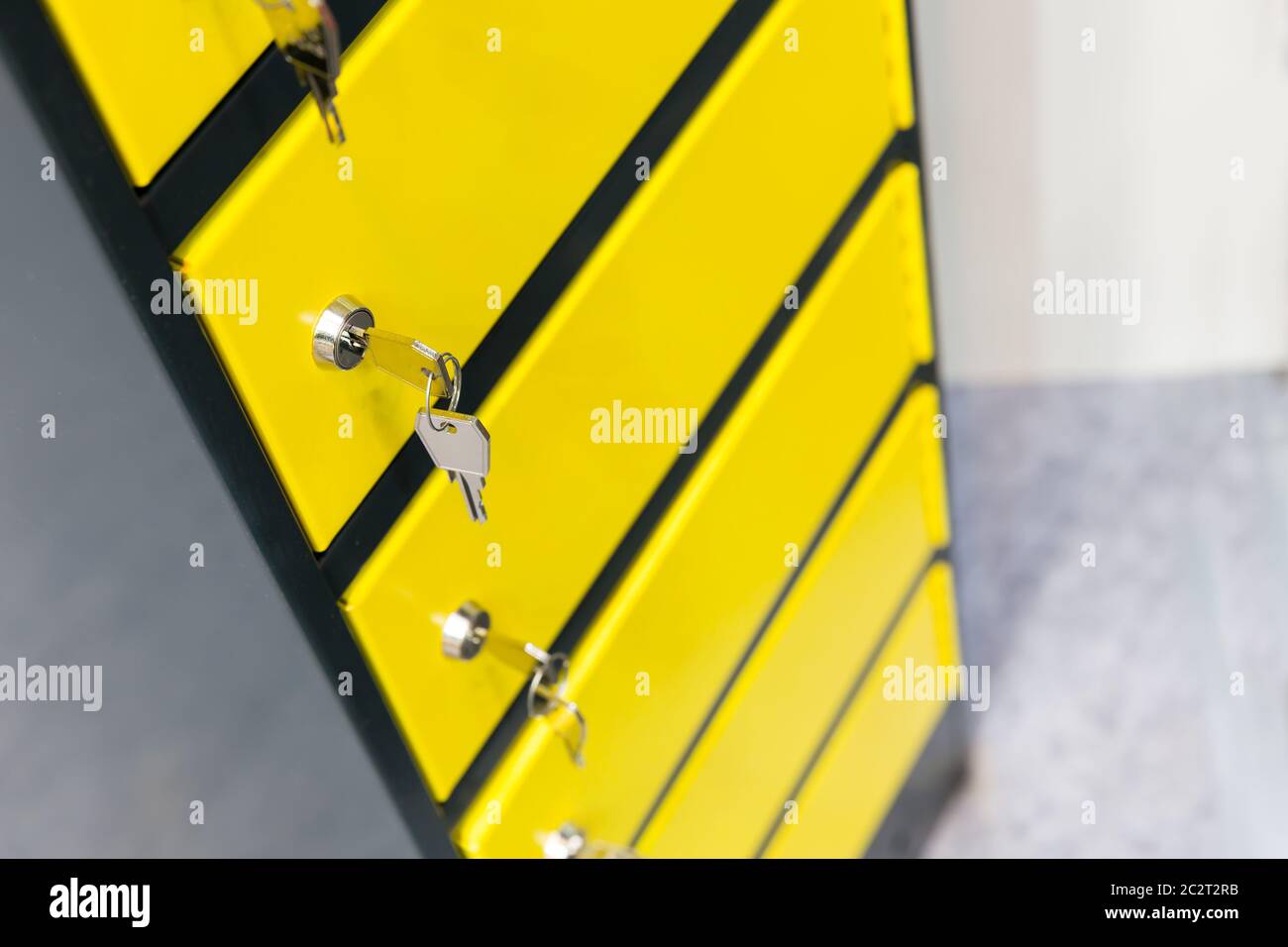 Yellow security cases with keys Stock Photo - Alamy