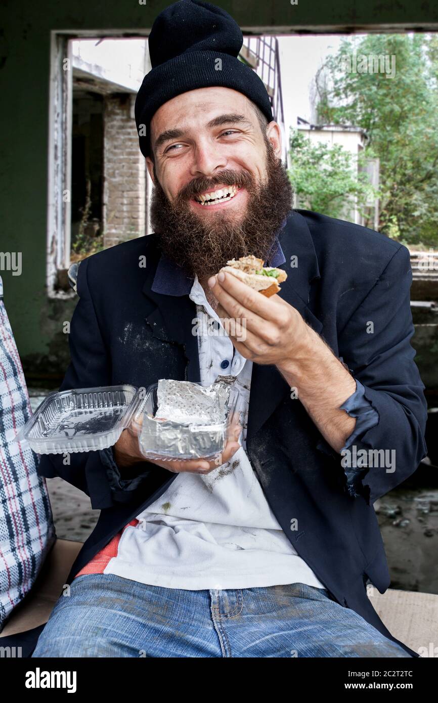 Happy homeless with food outdoor Stock Photo - Alamy